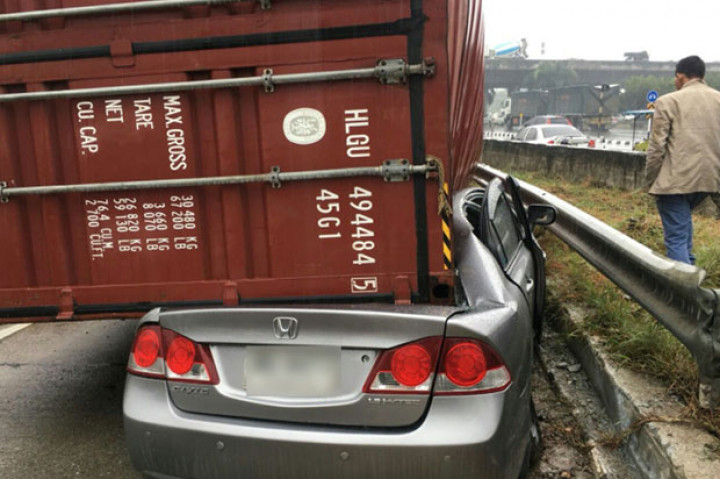 Bangkok Post - Falling container flattens car, driver survives