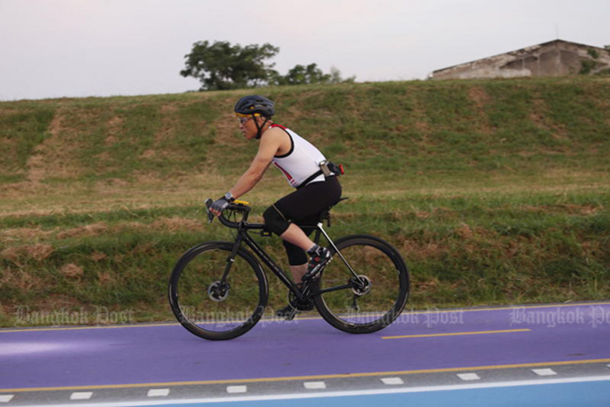 Bangkok Post - King opens and pedals airport bike track