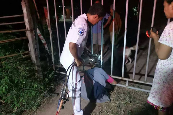 Bangkok Post - Woman spends painful night with head trapped in gate