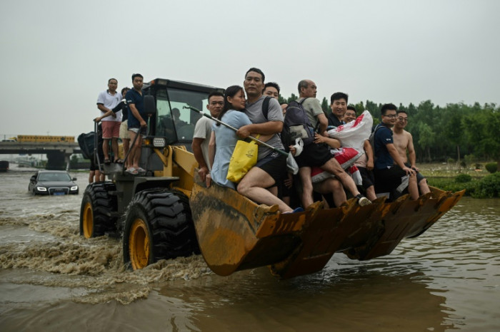 Bangkok Post - People flee surging floods in China as typhoon approaches