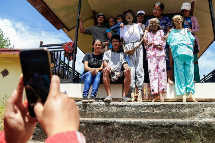 Bangkok Post - Dressing the dead: Indonesian villagers clean corpses in ...