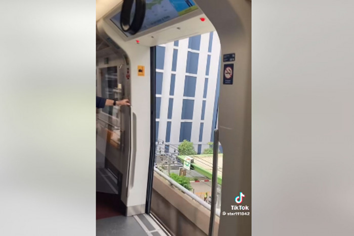 Bangkok Post - Open door on moving BTS train shocks passengers