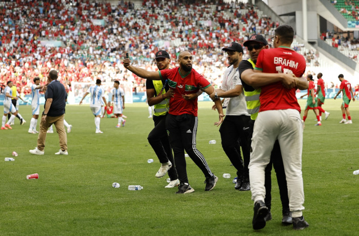 Bangkok Post - Pitch invasion mars Olympic football opener