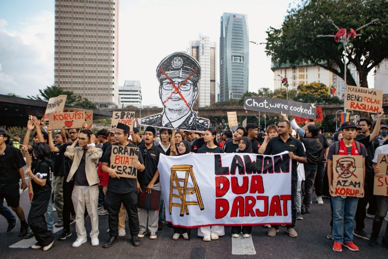 Bangkok Post - Crowds of black-clad Malaysians protest against anti ...