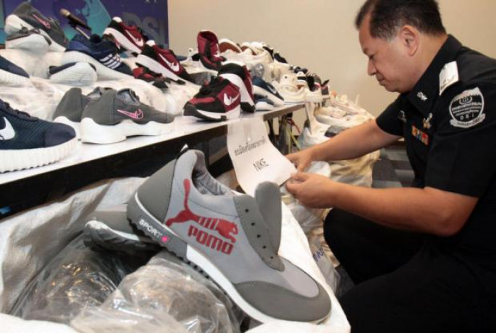Bangkok Post - 2 held as cops put boot into Chinese fake footwear scam